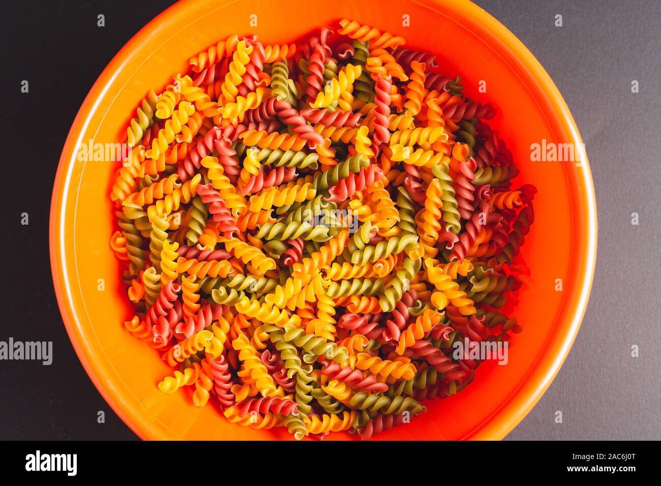 Uncooked tricolore fusilli pasta twist shapes background. Stock photo ...