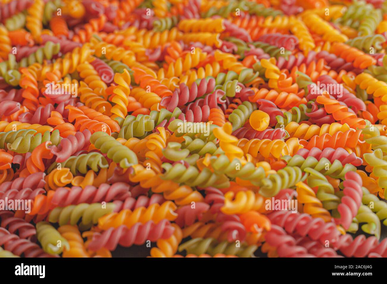 Uncooked tricolore fusilli pasta twist shapes background. Stock photo ...