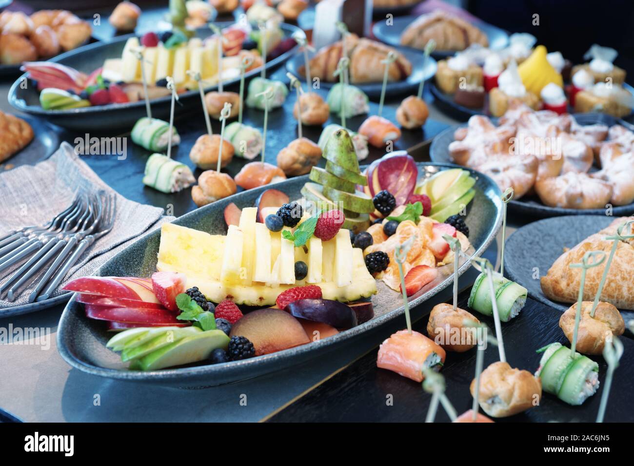 Various food on catering table, buffet at a reception, toned image ...
