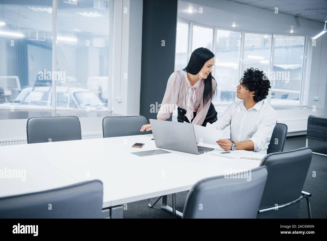 Looks like fun project. Cheerful coworkers in a modern office smiling ...