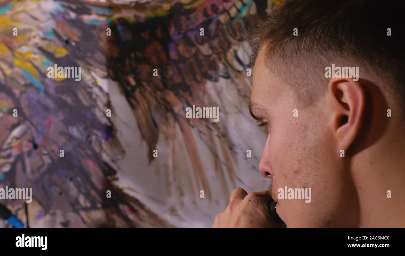 Artist designer draws an eagle on the wall. Craftsman decorator paints ...