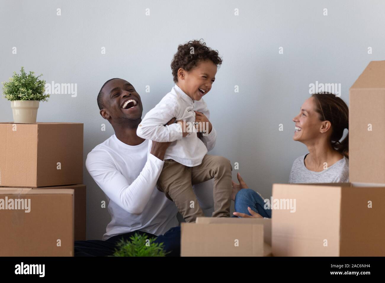 Happy laughing african american young man rising up joyful son Stock ...