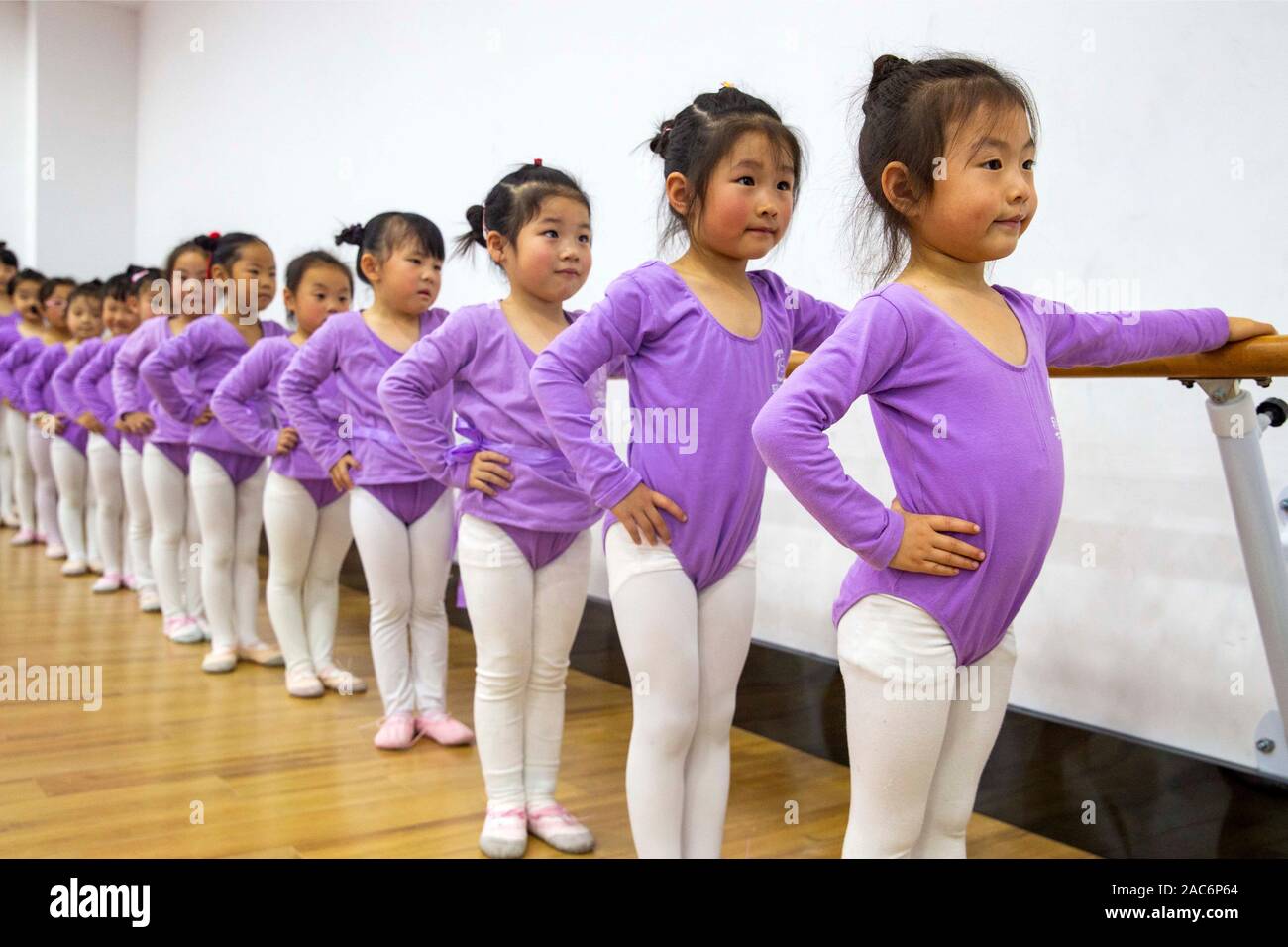 Little Chinese girls practise dancing during a training session at an ...