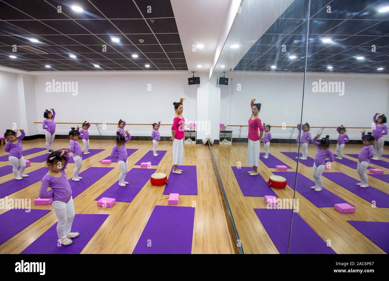 Little Chinese girls practise dancing during a training session at an ...