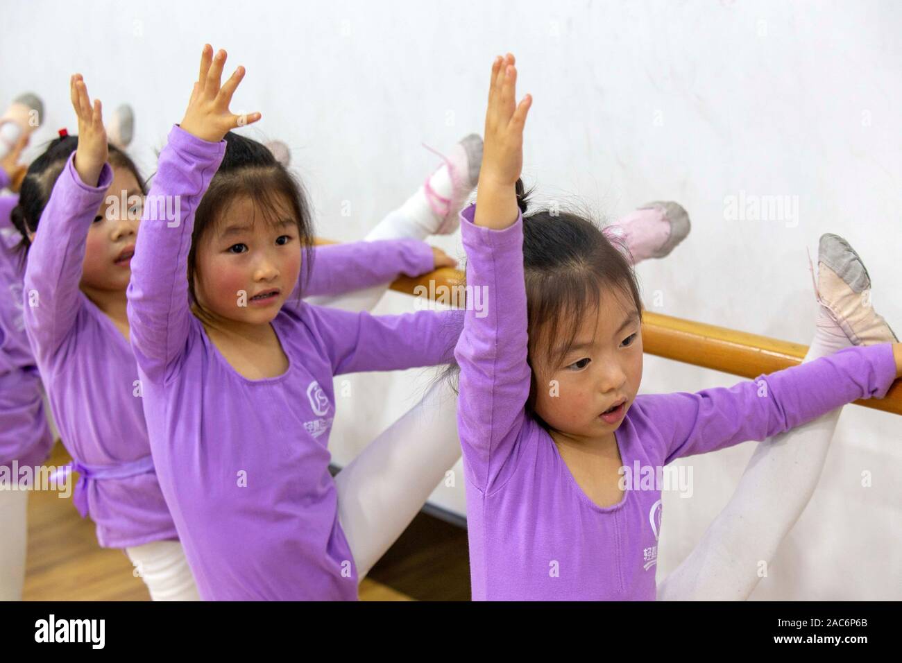 Little Chinese girls practise dancing during a training session at an ...