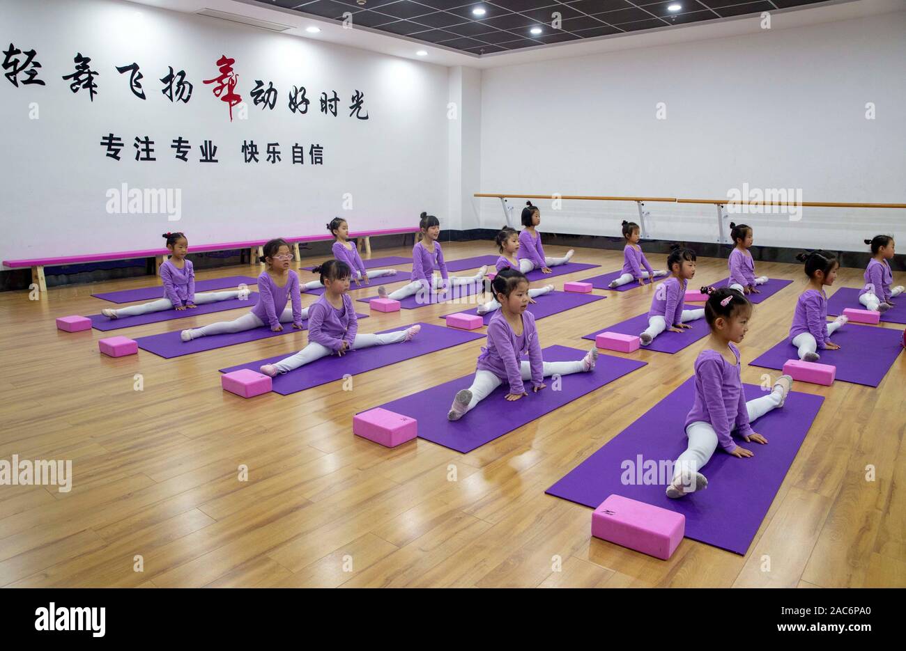 Little Chinese girls practise dancing during a training session at an ...