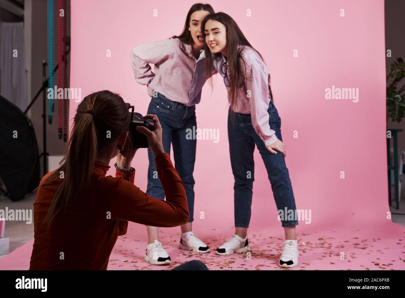 From below. Picture of two girls that photographed by female cameraman ...