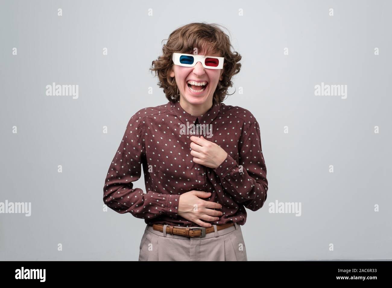 Funny caucasian woman watching comedy film in vintage stereo 3d glasses ...