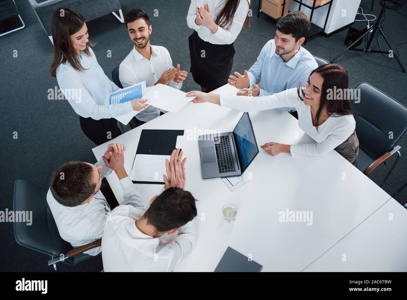 Happy people. Top view of office workers in classic wear sitting near ...