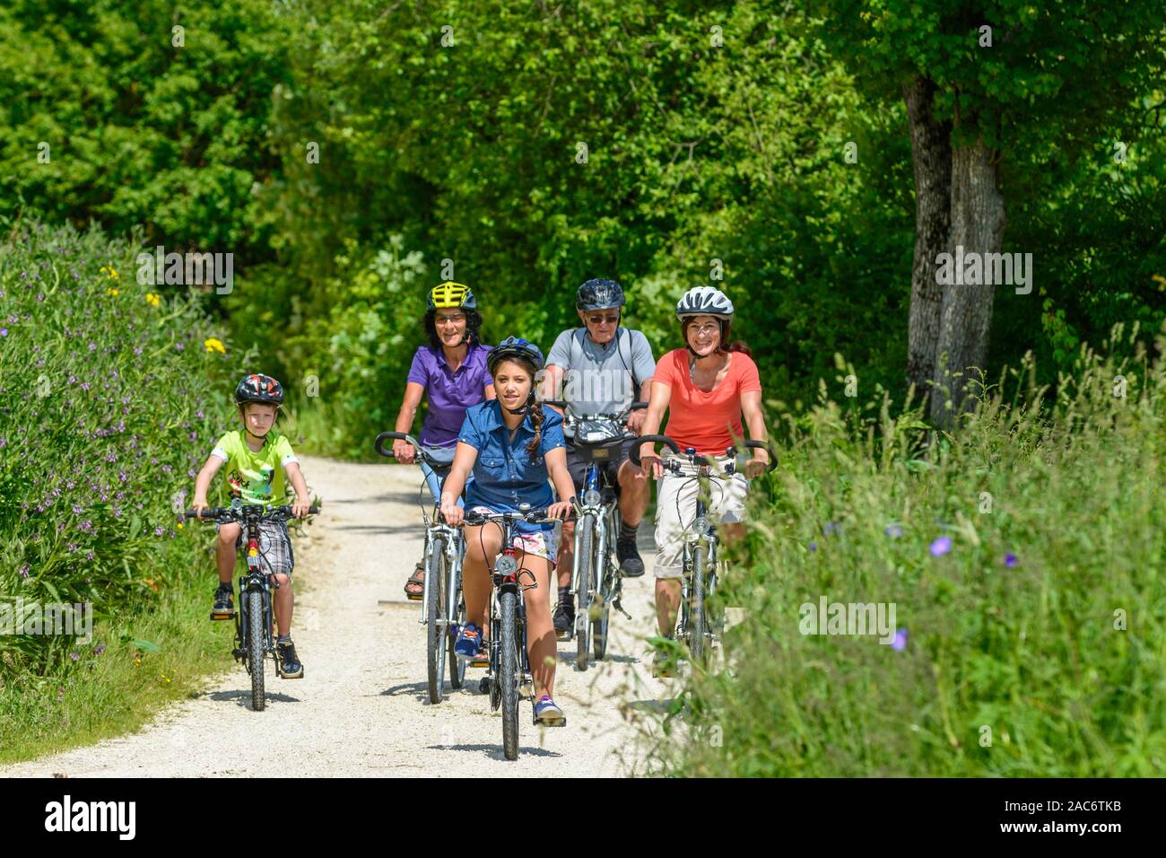 Three generations doing a cycling tour in beautiful nature in southern ...