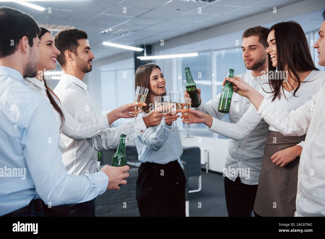 Sincere smiles. Standing and knocking the bottles and glass. In the ...