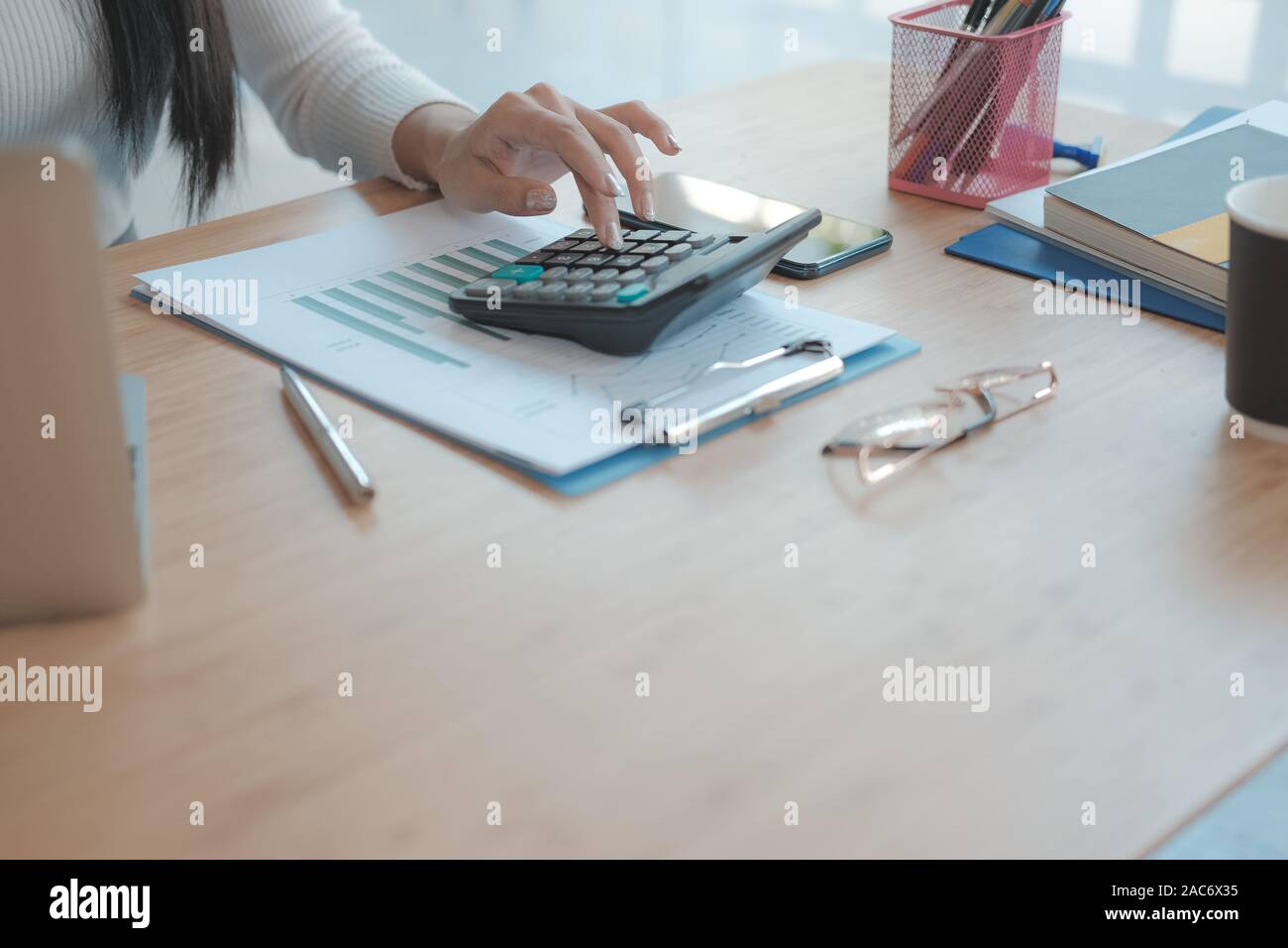 financial adviser working with calculator at office. accountant doing ...