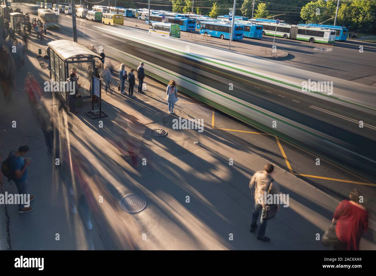 passengers in the queue for boarding the bus on a busy street at the ...