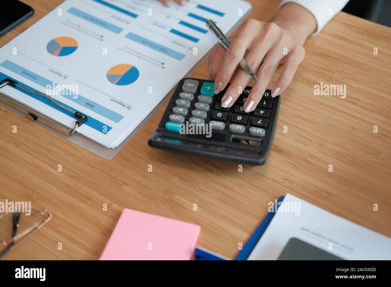 financial adviser working with calculator at office. accountant doing ...