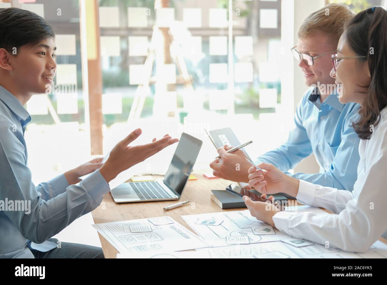 user experience UX designer designing web on smart phone layout. UI planning mobile application ...
