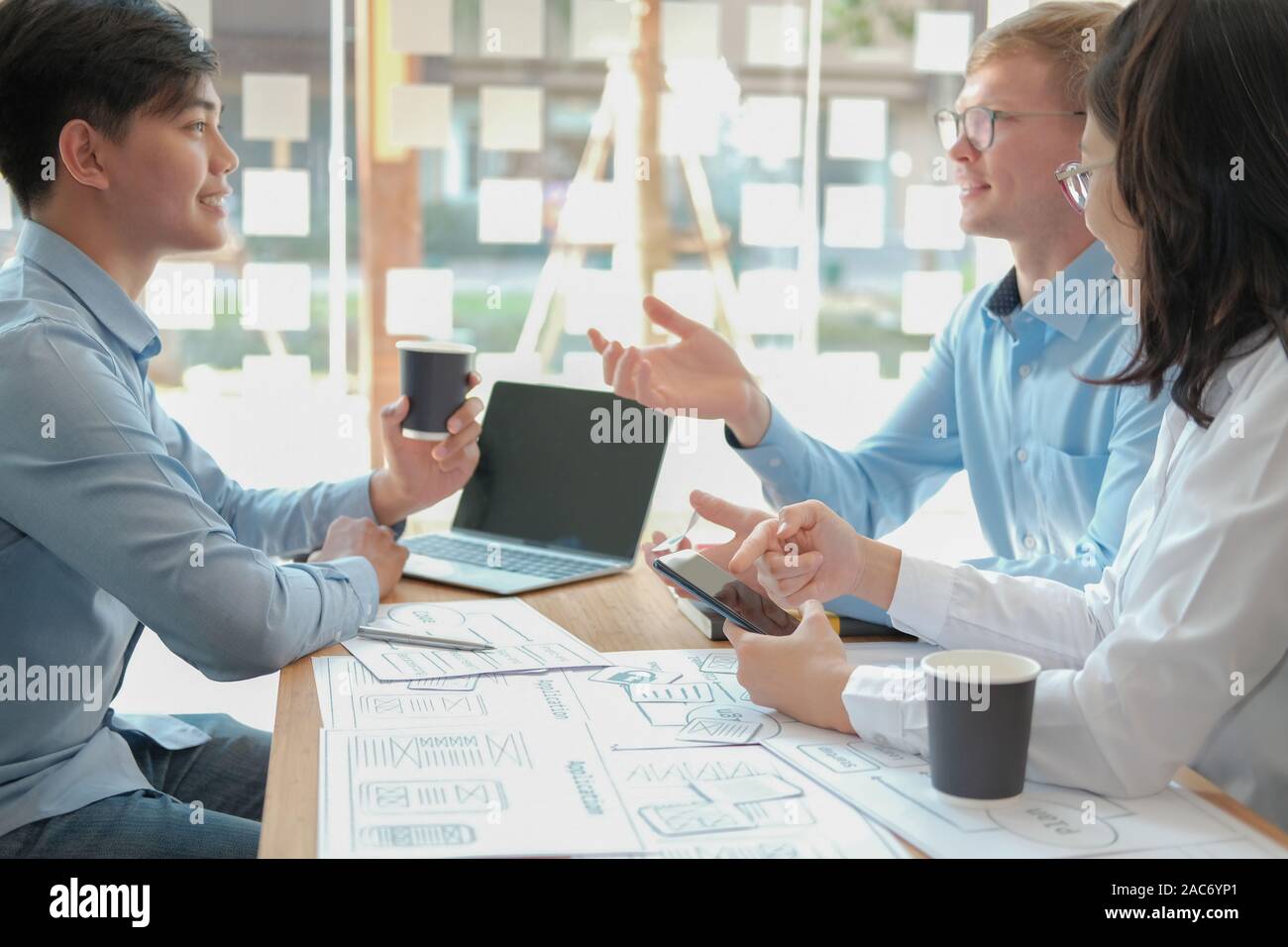 user experience UX designer designing web on smart phone layout. UI planning mobile application ...