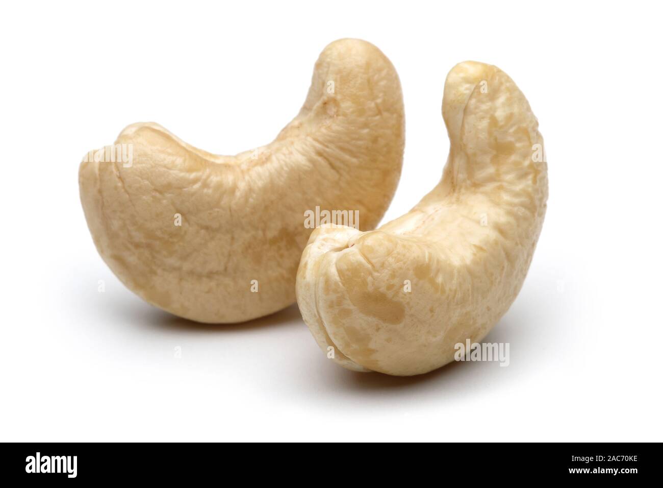 Two raw cashew nuts isolated on white background Stock Photo - Alamy
