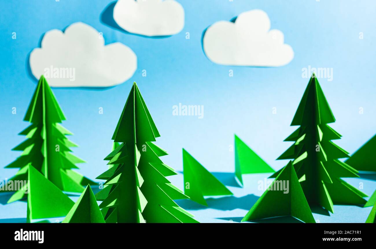 Origami forest landscape. Green Christmas trees, pines, and blue sky ...
