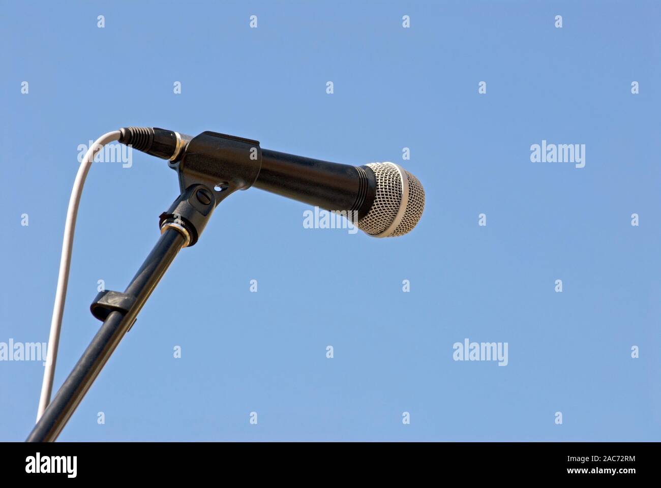 One outdoor microphone on a pole with a clear blue sky background Stock ...
