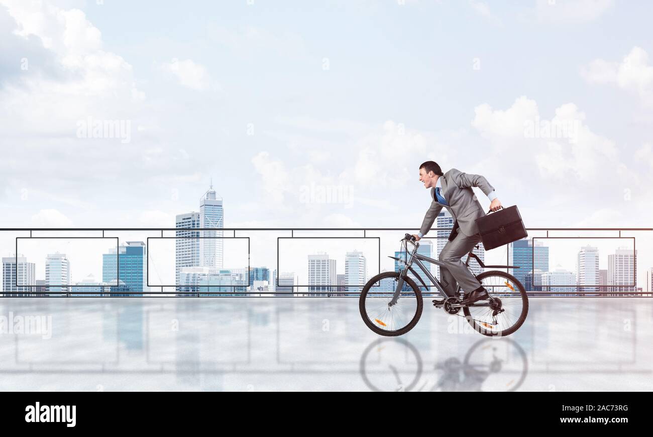 Man riding bicycle on penthouse balcony Stock Photo - Alamy