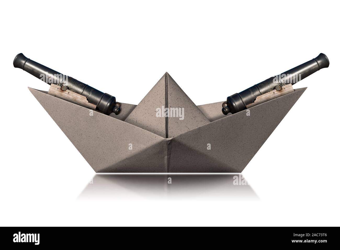 Warship with two old cannons, small paper boat isolated on white ...