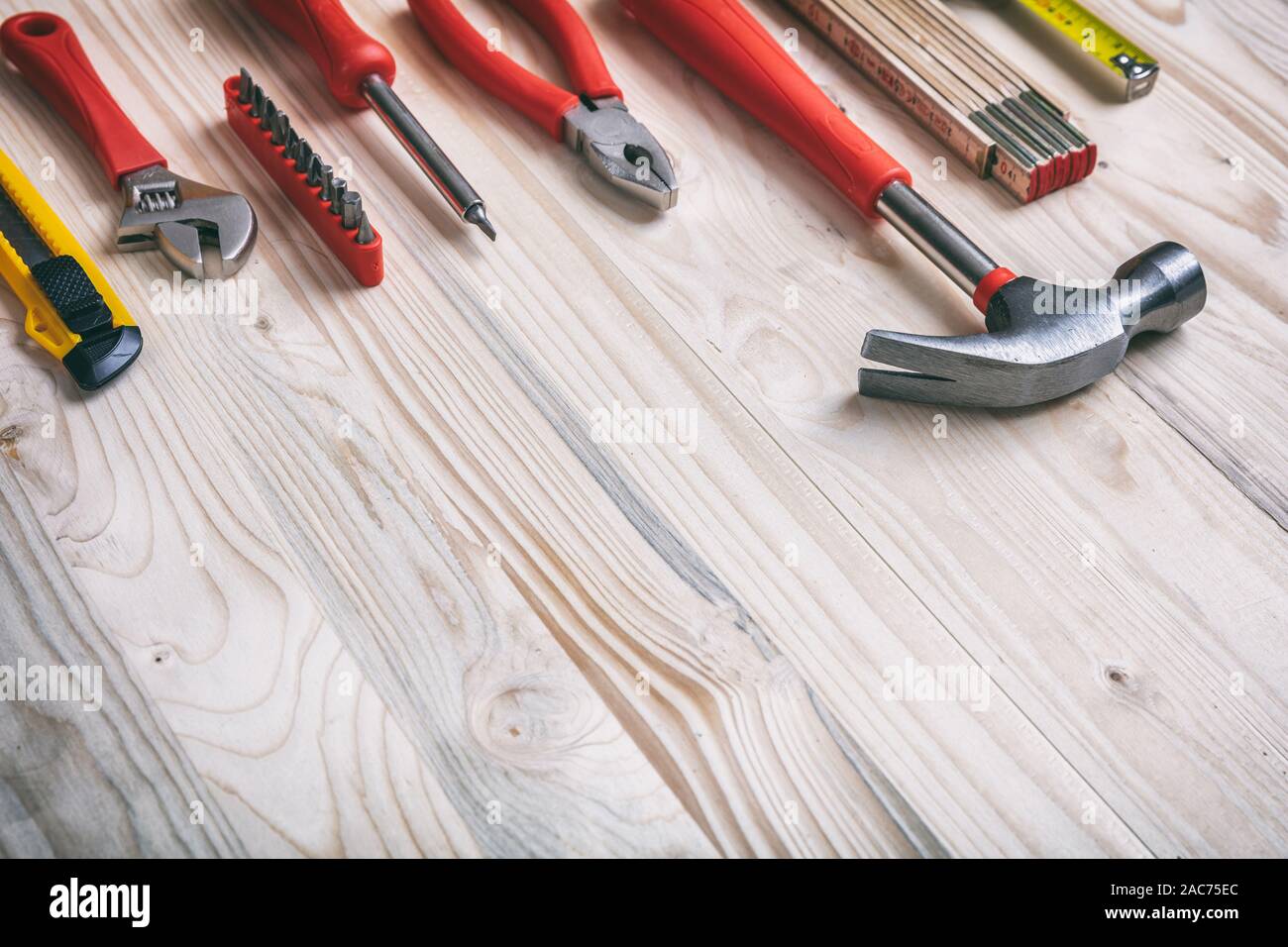 Hand tools set red and yellow color on wood, copy space, close up view ...