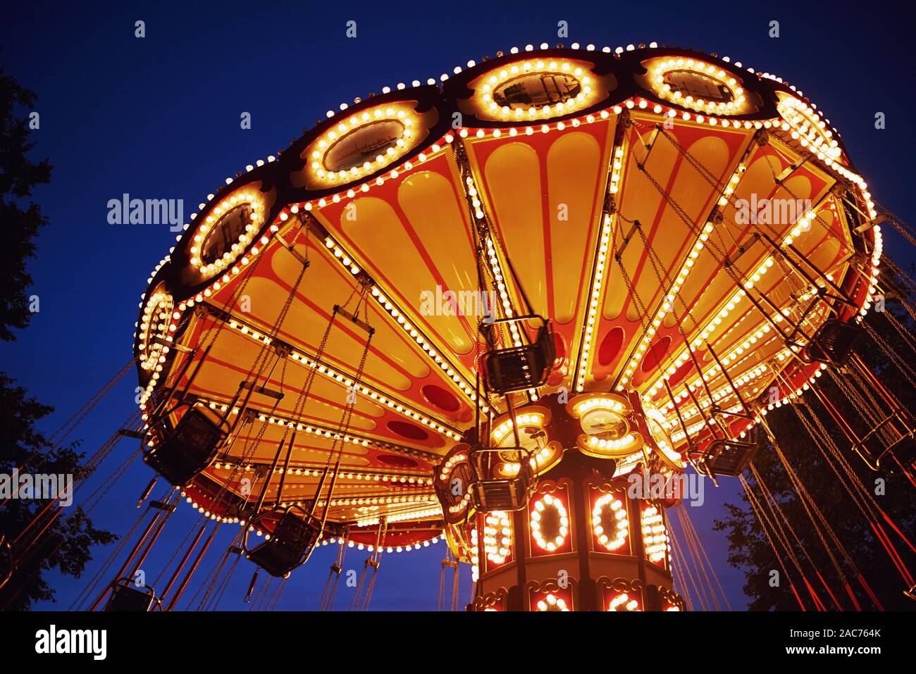 Carousel Merry-go-round in amusement park at night city Stock Photo - Alamy