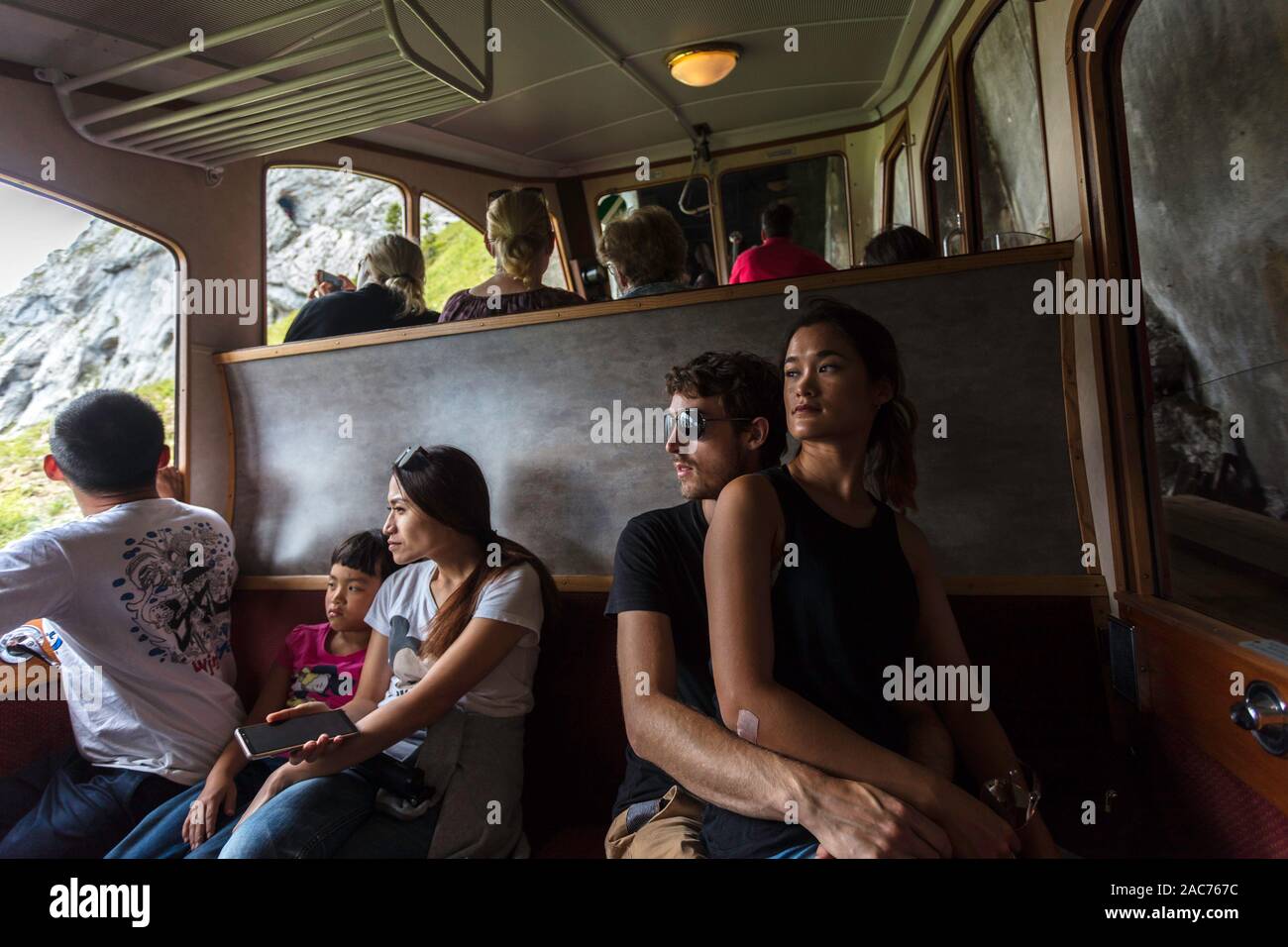Tourists inside the cog railway riding to mount Pilatus, Lucerna ...