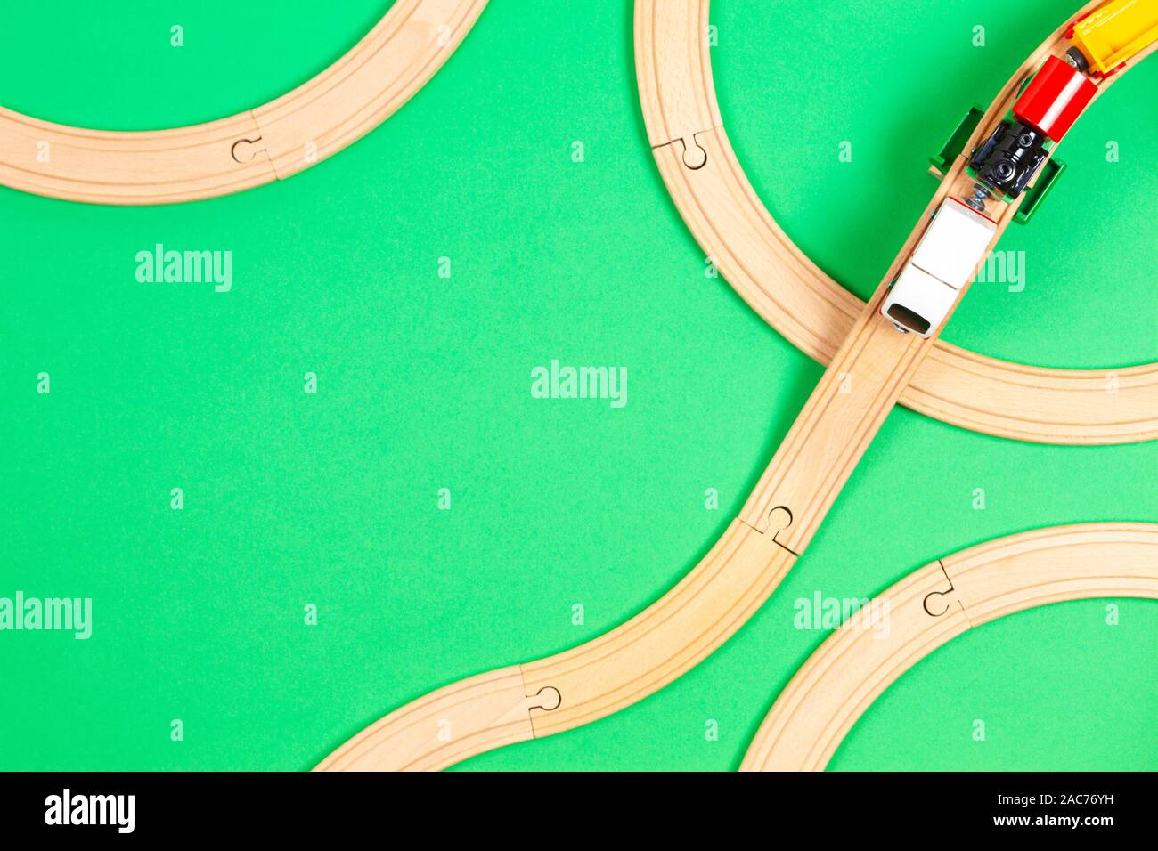 Baby kid toys background. Toy train and wooden rails on light green ...