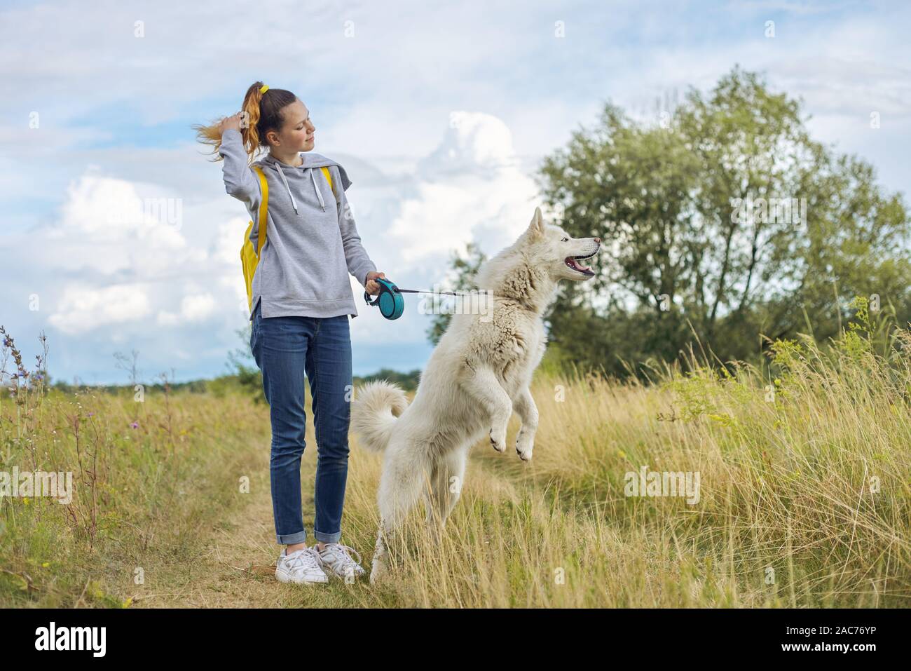 Beautiful girl with white dog, teenager walking with husky pet ...
