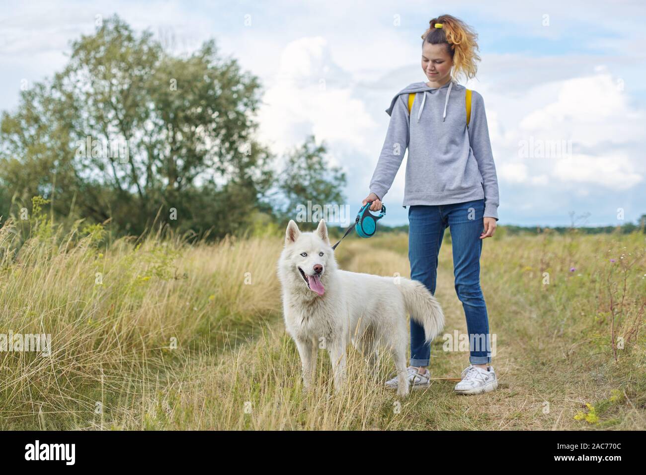 Beautiful girl with white dog, teenager walking with husky pet ...
