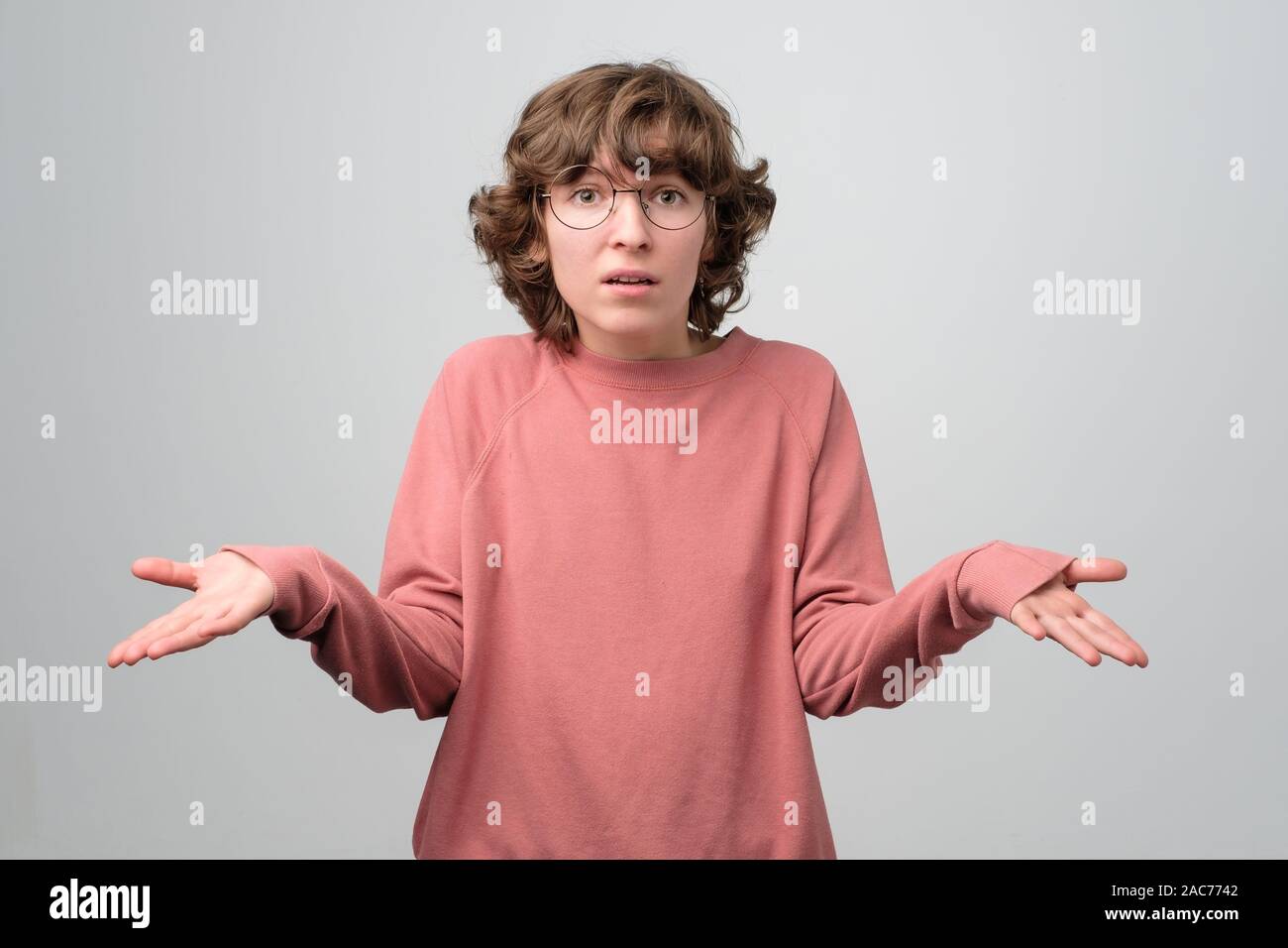 Shrugging pose hi-res stock photography and images - Alamy
