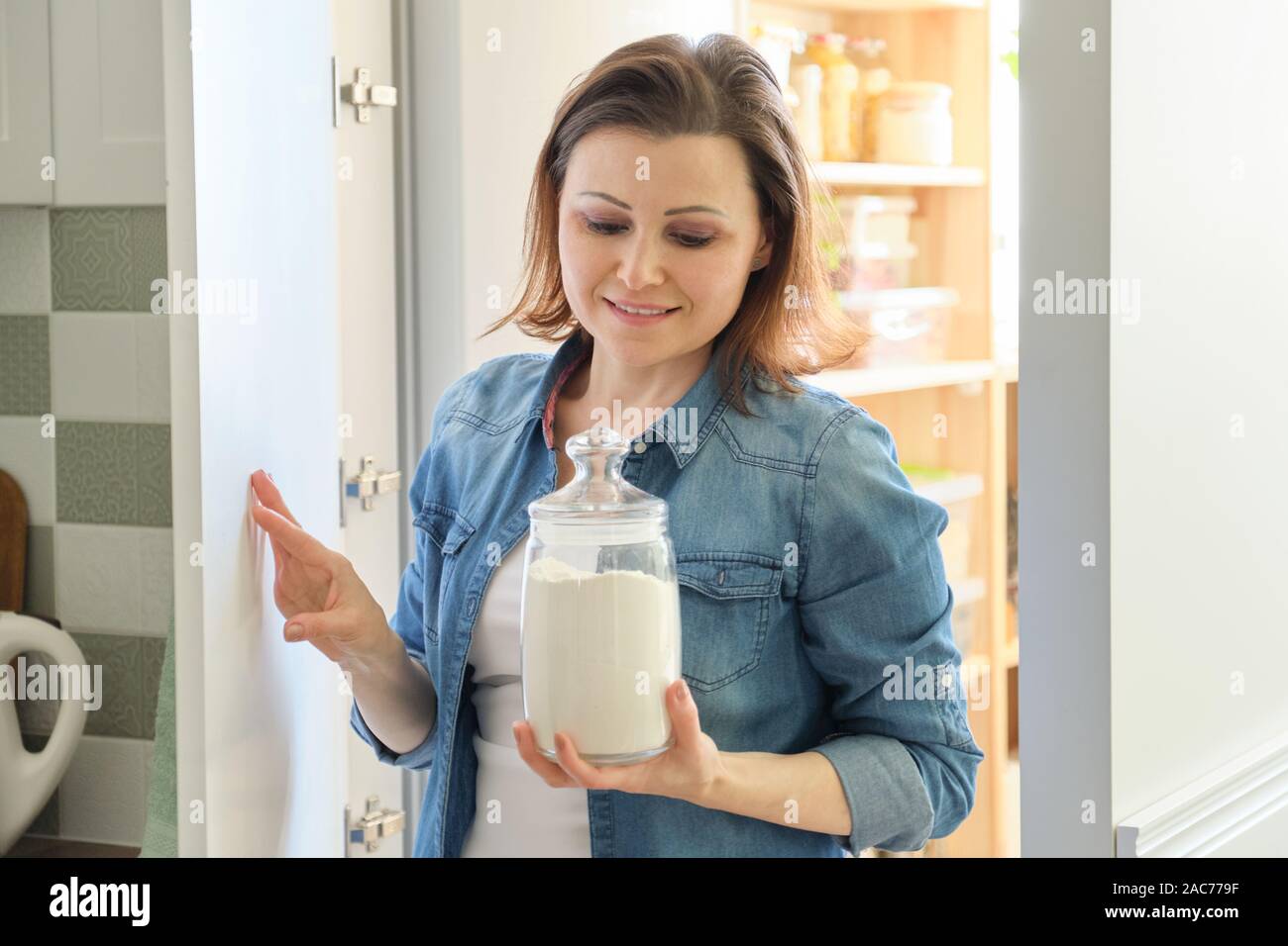 Adult woman in kitchen interior with food products, preparing healthy ...