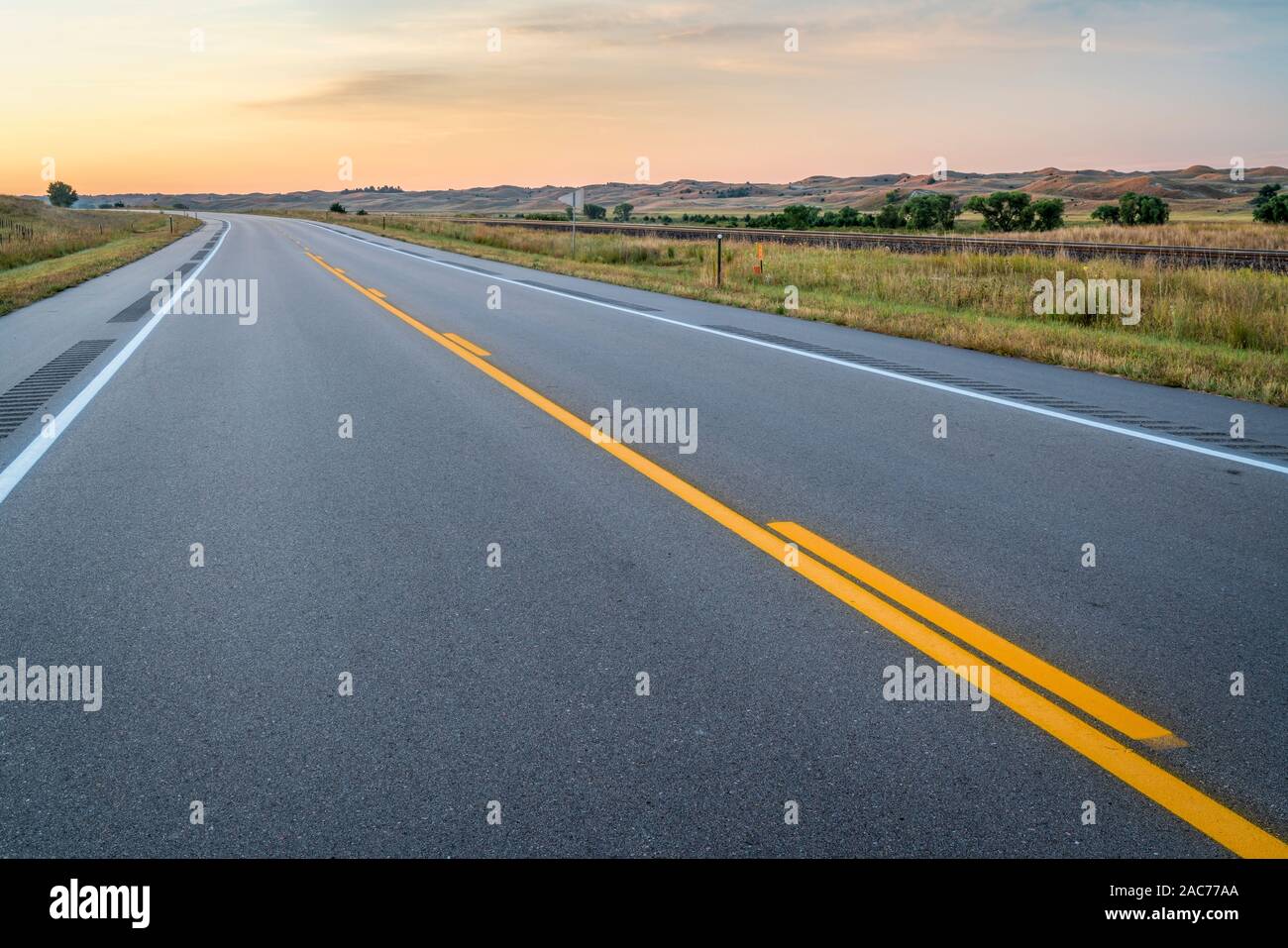 empty highway and railway tracks along a valley of the Middle Loup ...