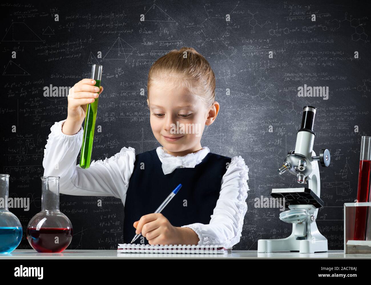 Little girl scientist examining test tube Stock Photo - Alamy
