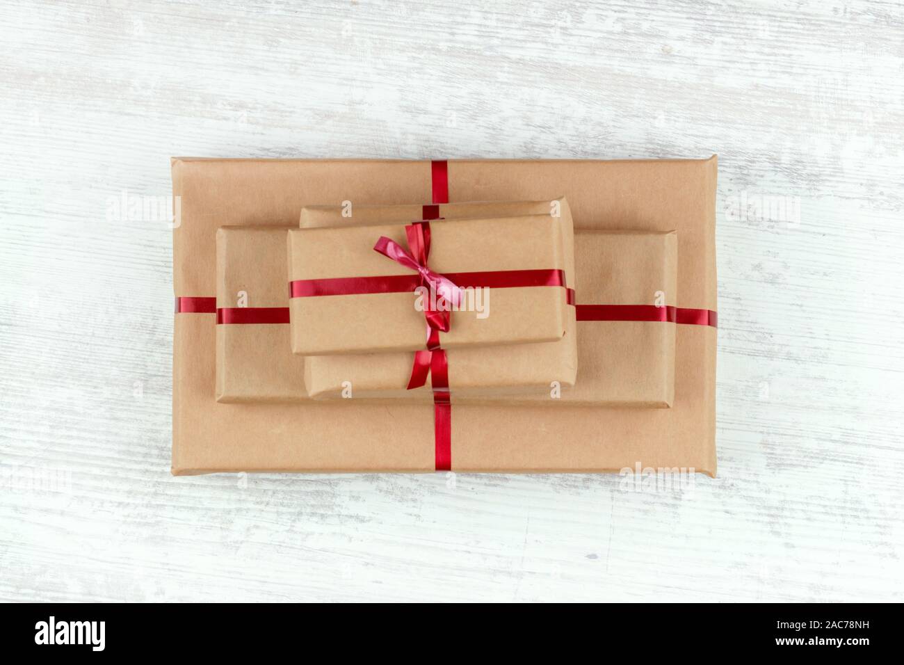 Gift Boxes in Craft Wrapping Paper with the Red Ribbons isolated Stock ...