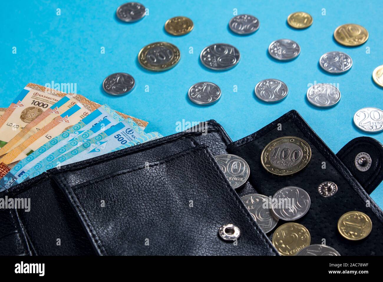 Tenge on blue background with coins. Tenge is the national currency of ...