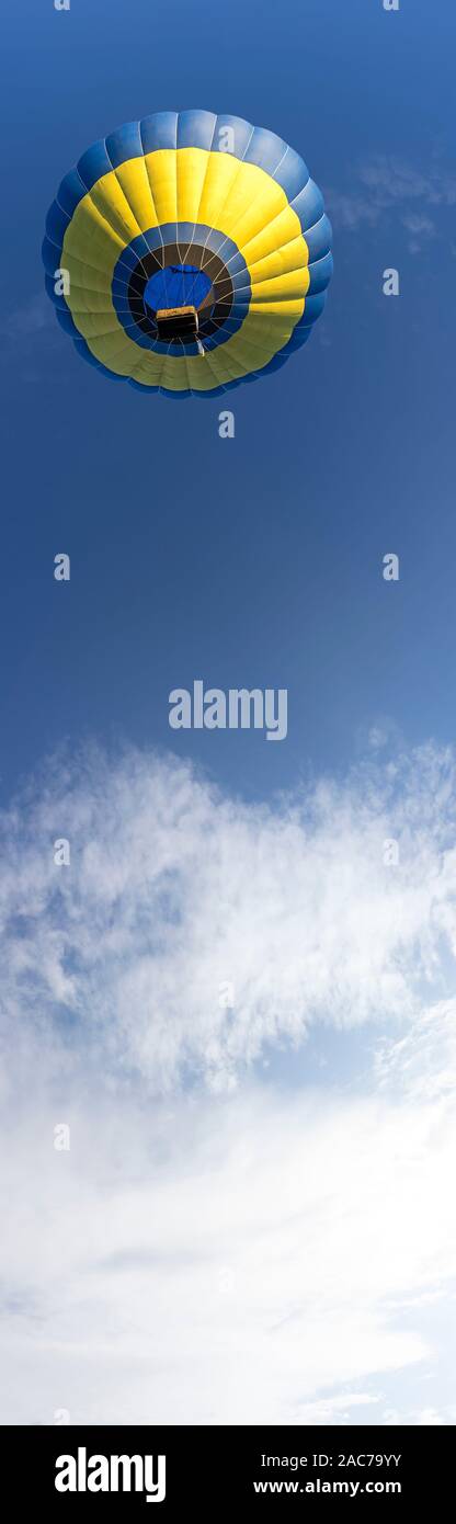 Balloon soaring above the clouds. Vertical Stock Photo - Alamy