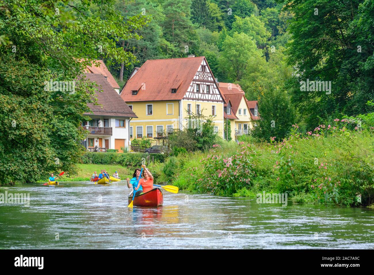 Group of people doing canoe tour on idyllic river in franconia Stock ...