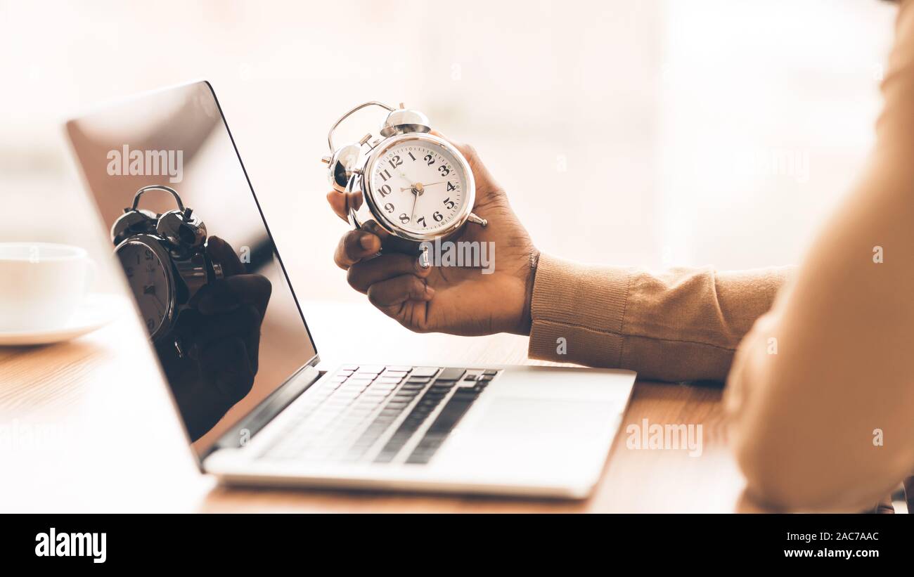 Unrecognizable afro guy checking time on his clock Stock Photo - Alamy
