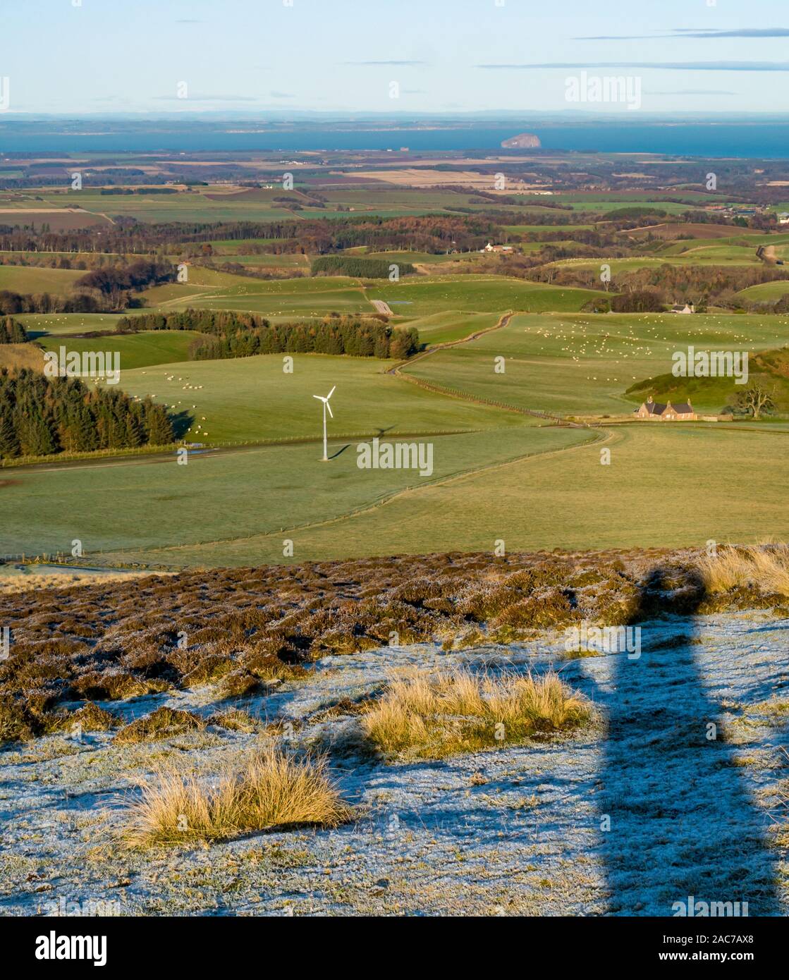 View from hill above farm house and wind turbine, rural landscape ...