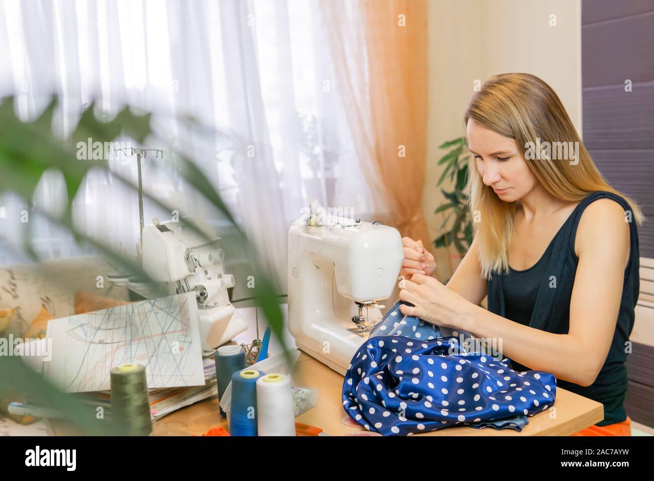 Woman among sewing machine hi-res stock photography and images - Alamy