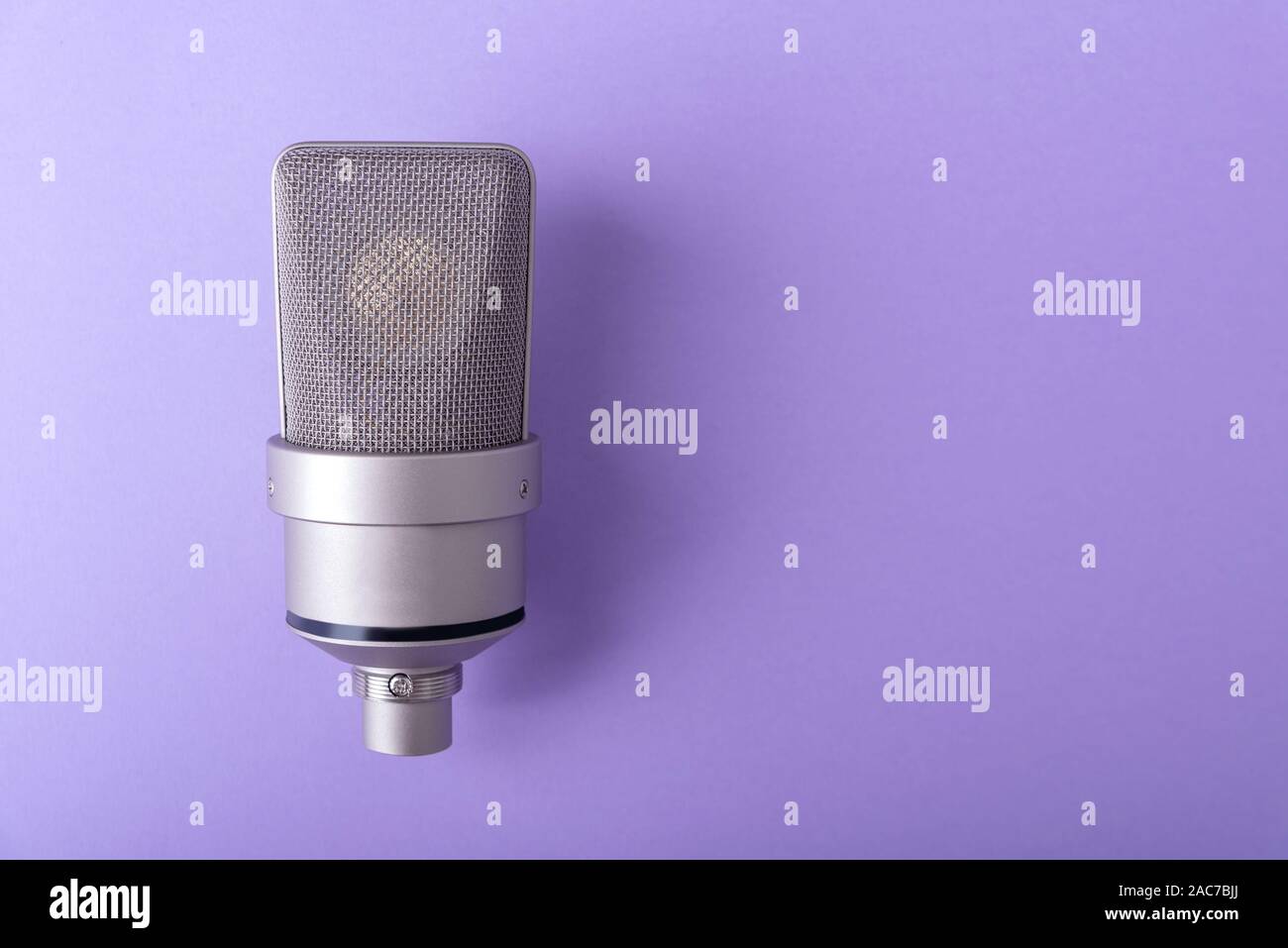 Large diaphragm condenser studio microphone. On purple background Stock ...