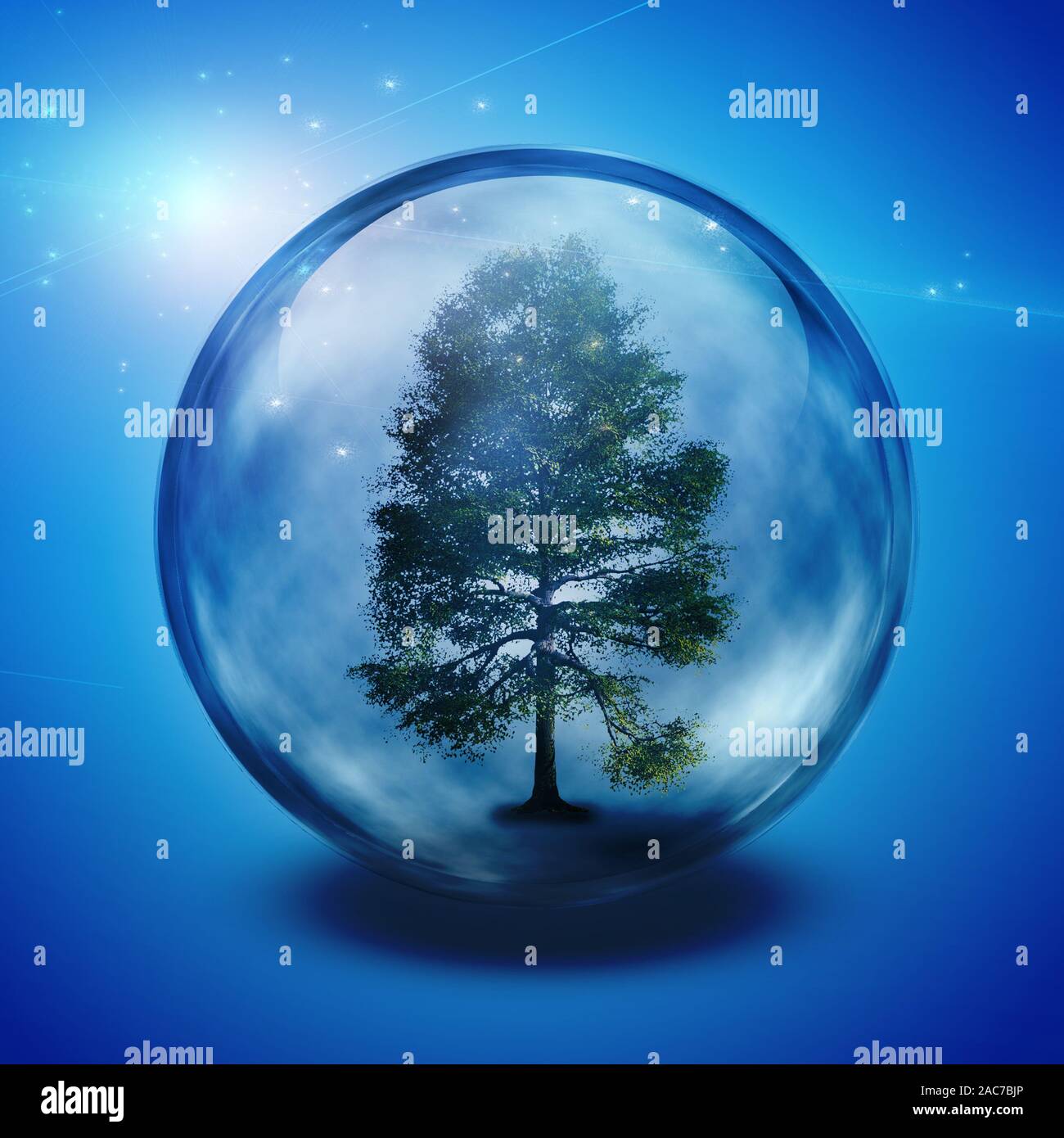 Green tree inside crystal ball Stock Photo - Alamy