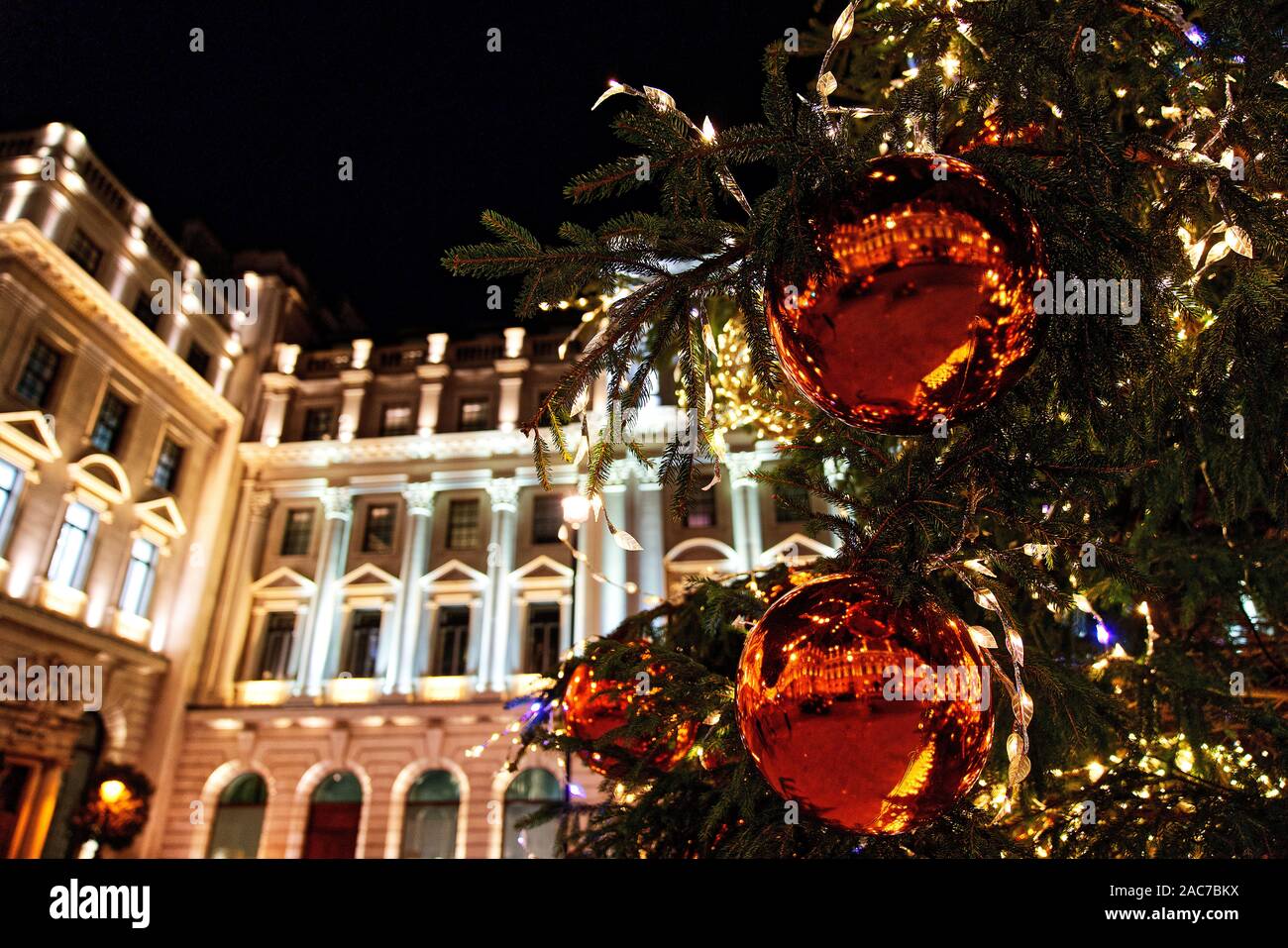 Christmas tree with buildings in background Stock Photo - Alamy