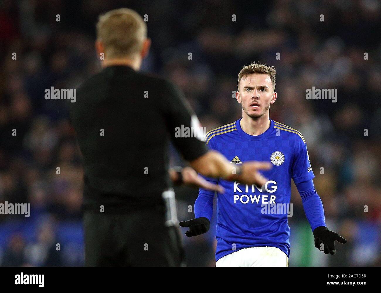 Leicester City's James Maddison (right) has words with referee Graham ...