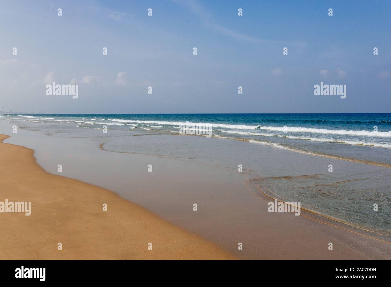 Beautiful, empty tropical white sand beach, small waves in the sea ...