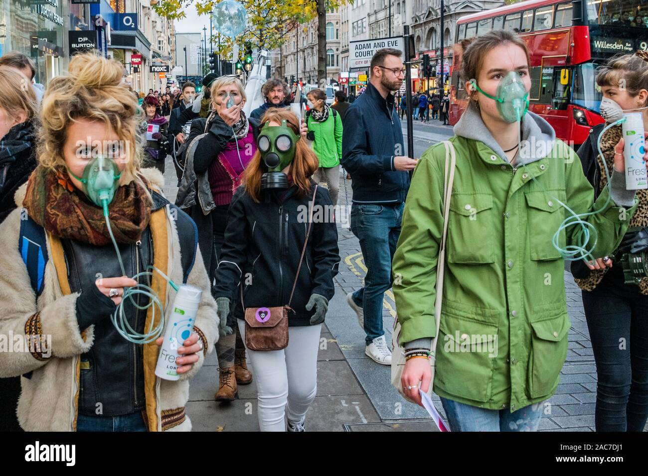 London, UK. 1st Dec 2019. Marching down Oxford street in gas masks ...
