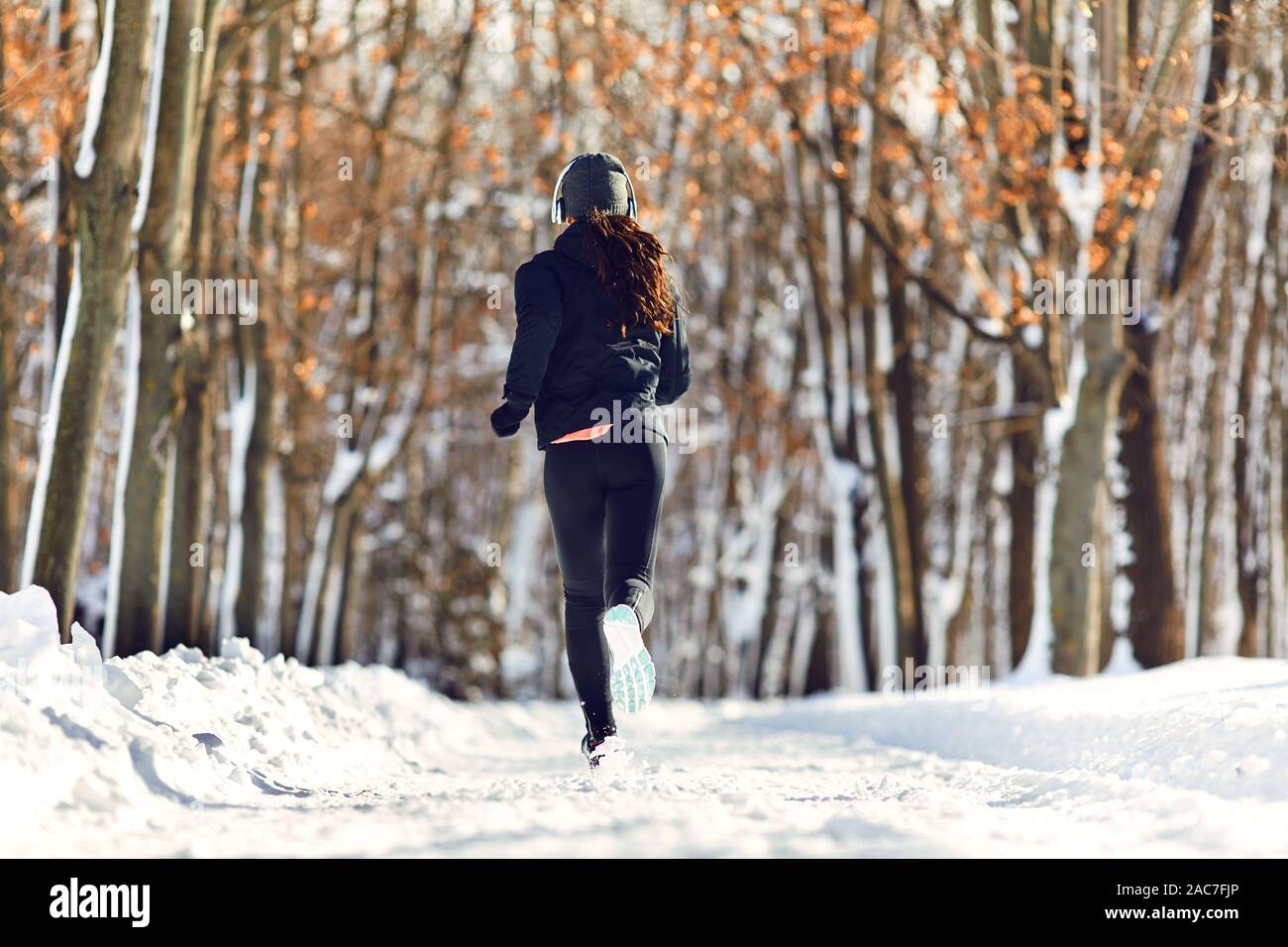 A girl runs through the park in winter Stock Photo - Alamy