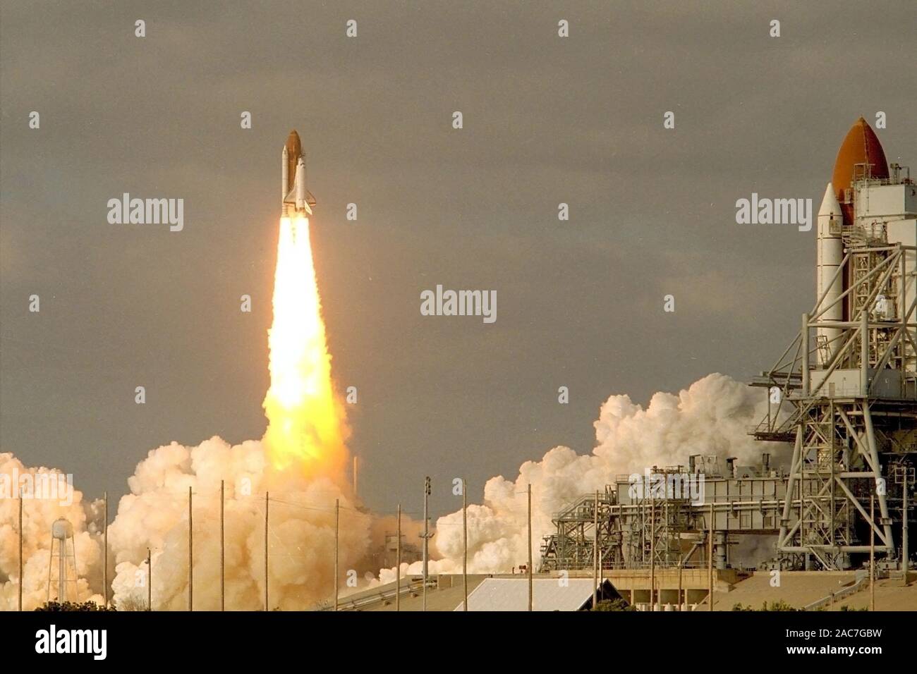 The launch of the space shuttle, with smoke and fire. Elements of this ...